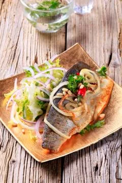 Pan fried trout fillet garnished with salad greens and onion, 20551964 ...