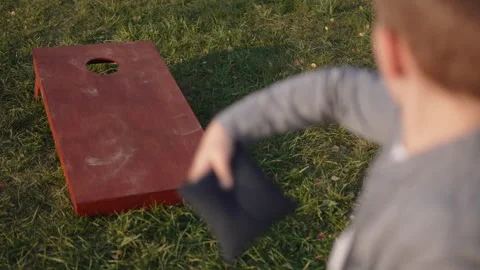 10 year old child is trying to hit hole ... | Stock Video | Pond5