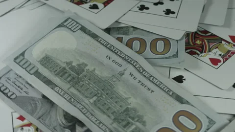 $100 Bills Cascade Onto Playing Cards Ro... | Stock Video | Pond5
