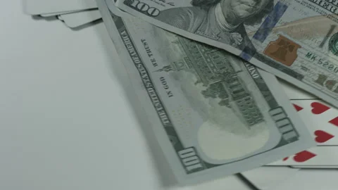 $100 Bills Cascade Onto Playing Cards Ro... | Stock Video | Pond5