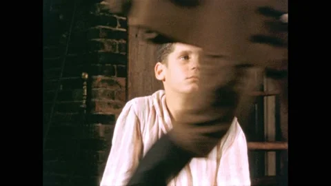 1700s: Colonial boy sits on floor and wa... | Stock Video | Pond5