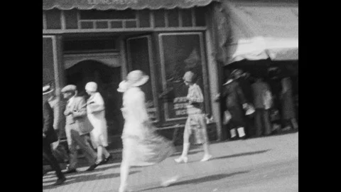 1920s: crowd walks in front of stores an... | Stock Video | Pond5