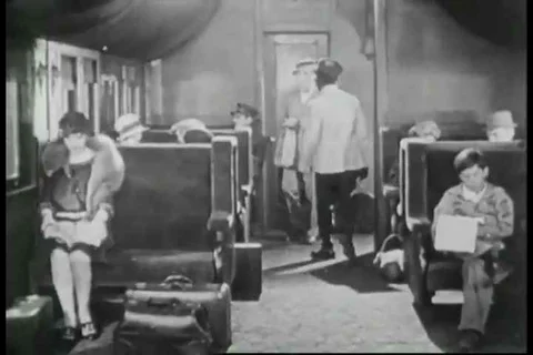 1927 - A man causes chaos by spritzing i... | Stock Video | Pond5