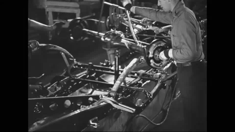 1930s - Car factory workers put the whee... | Stock Video | Pond5
