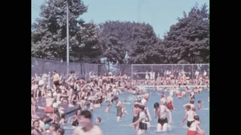 1930s: Crowd lounge around a pool, while... | Stock Video | Pond5