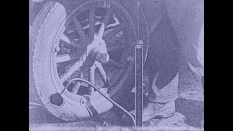 1930s: Hands pump air into tire, animate... | Stock Video | Pond5