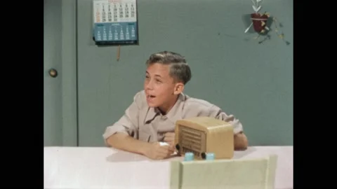 1940s: Boy at table with radio. Boy wash... | Stock Video | Pond5