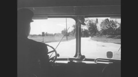 1940s: Bus driver drives bus through int... | Stock Video | Pond5