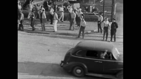 1940s: Cars pass picket line, men waving... | Stock Video | Pond5