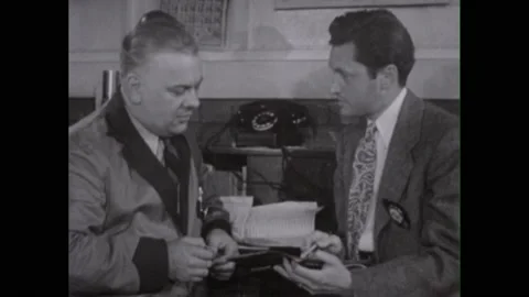 1940s: Foreman talks to man in suit and ... | Stock Video | Pond5