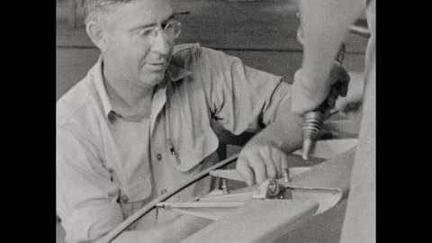 1940s: hands pick up and point to rivets... | Stock Video | Pond5