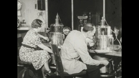 1940s: Lab, man, woman sit at table, wor... | Stock Video | Pond5