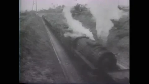 1940s: Locomotive pulls train cars on ra... | Stock Video | Pond5