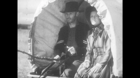 1940s: Man and woman ride in covered wag... | Stock Video | Pond5