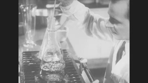 1940s: Man in chemistry lab measures boi... | Stock Video | Pond5