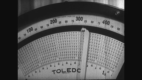 1940s: Needle on scale moves. Woman ligh... | Stock Video | Pond5