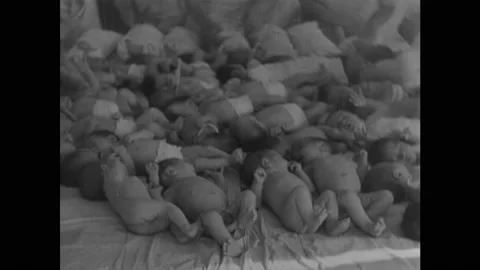 1940s: Nurses stand over table full of b... | Stock Video | Pond5