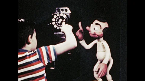 1940s: Puppet speaks to boy as he dials ... | Stock Video | Pond5