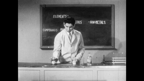 1940s: Scientist at lab bench mixes iron... | Stock Video | Pond5