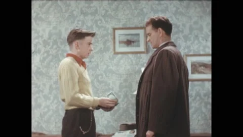 1940s: Slate. Boy examines money. He tak... | Stock Video | Pond5