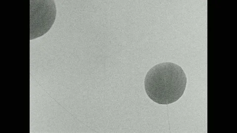 1940s: Tethered weather balloons float i... | Stock Video | Pond5