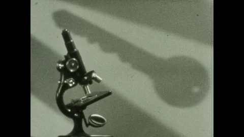 1940s: View of microscope, shadow of key... | Stock Video | Pond5