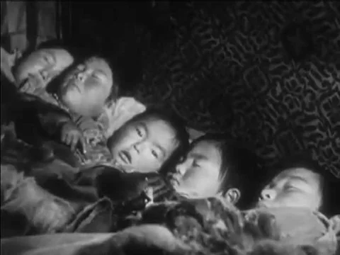 1941-Eskimo children sleep in a bed with... | Stock Video | Pond5