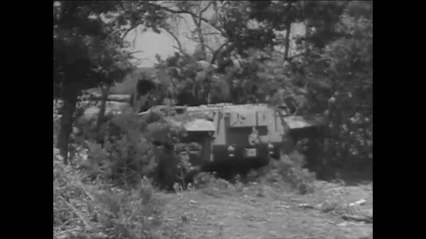 1950 - A tank emerges from a wooded area... | Stock Video | Pond5