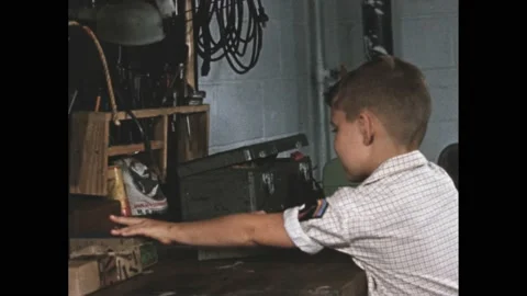 1950s: Boy removes boxes of nails from w... | Stock Video | Pond5