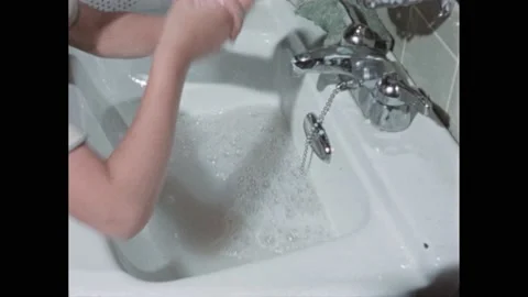 1950s: Boy washes hands in bathroom sink... | Stock Video | Pond5