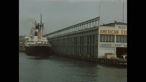 1950s: Cargo ship at dock next to a ware... | Stock Video | Pond5