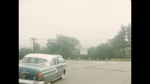 1950s: Cars pull out and turn left and t... | Stock Video | Pond5