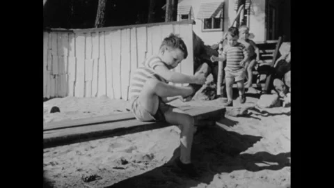 1950s: Children run down to beach. Child... | Stock Video | Pond5