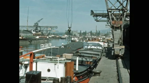 1950s: Cranes load boxes onto cargo ship... | Stock Video | Pond5