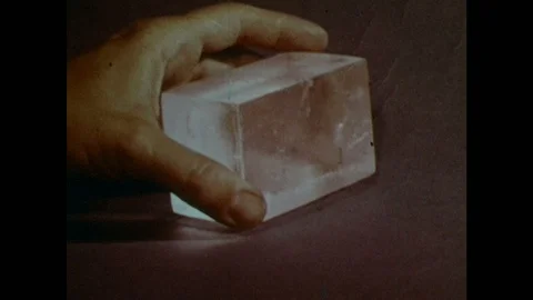 1950s: Hand places block of crystal on t... | Stock Video | Pond5