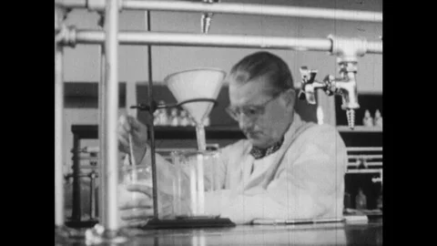 1950s: Lab. Man stirs liquid in beaker.... | Stock Video | Pond5