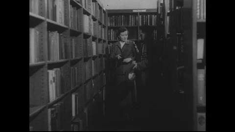 1950s: Librarian takes books from shelve... | Stock Video | Pond5