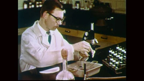 1950s: Man in lab coat places bottle wit... | Stock Video | Pond5