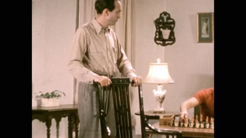 1950s: man stands with hands on back of ... | Stock Video | Pond5