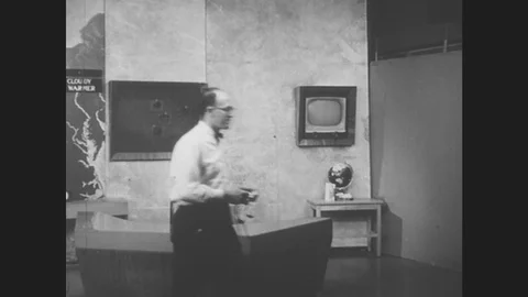 1950s: Man walks across TV studio. Man t... | Stock Video | Pond5
