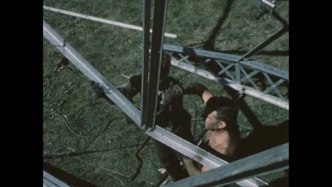 1950s: Men line up the metal framing of ... | Stock Video | Pond5