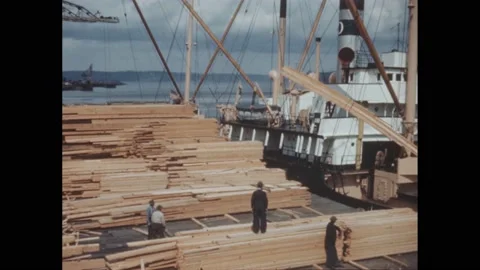 1950s: Men load lumber onto ship. | Stock Video | Pond5