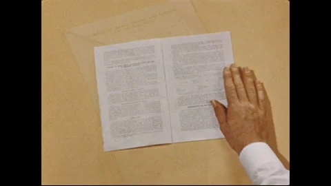 1950s: Pamphlet lays on table. Hand turn... | Stock Video | Pond5