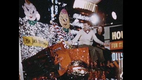 1950s: Parade. Man on red float waves at... | Stock Video | Pond5