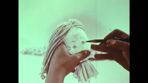 1950s: Person draws face on hand puppet. | Stock Video | Pond5