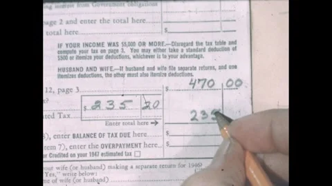 1950s: Person fills out tax return form. | Stock Video | Pond5
