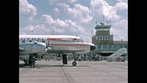 1950s: Plane parked by flight tower, man... | Stock Video | Pond5