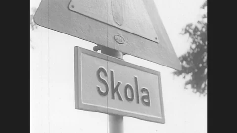 1950s: Road sign with text "Skola". Chil... | Stock Video | Pond5