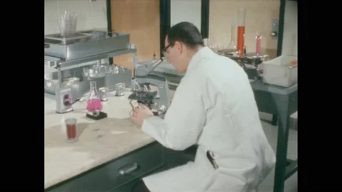 1950s: Scientist at the bench, looks a s... | Stock Video | Pond5