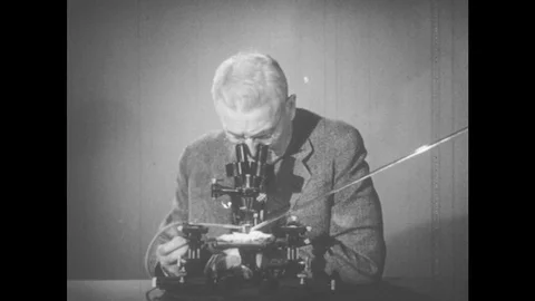 1950s: A scientist looks into his micros... | Stock Video | Pond5